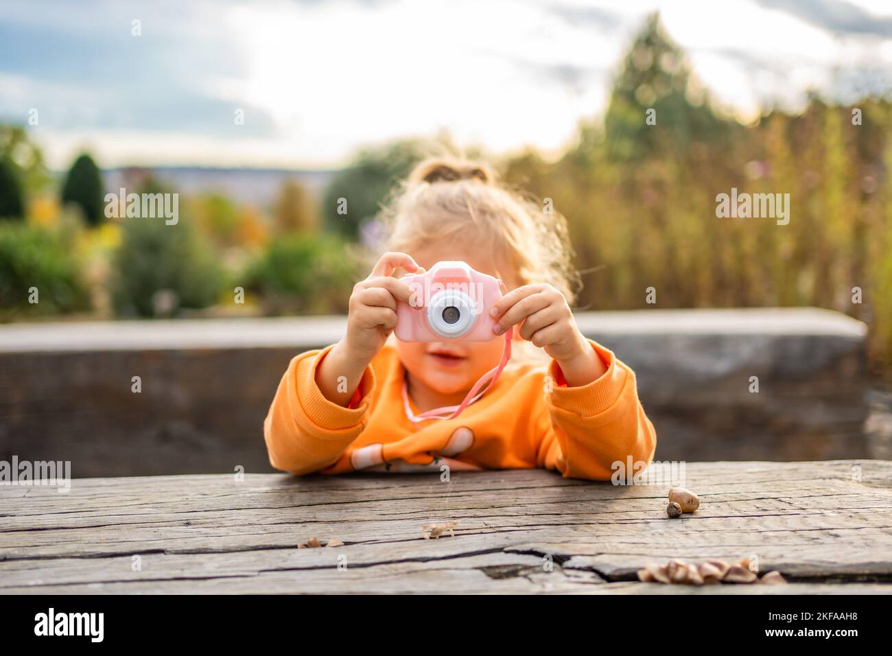 Toddler Girl Taking Pictures with Pink Digital Children's Camera in the ...