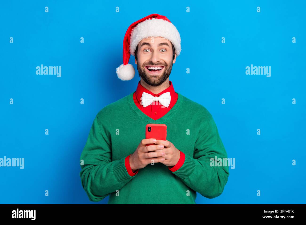 Photo of astonished crazy guy beaming smile hold telephone isolated on ...