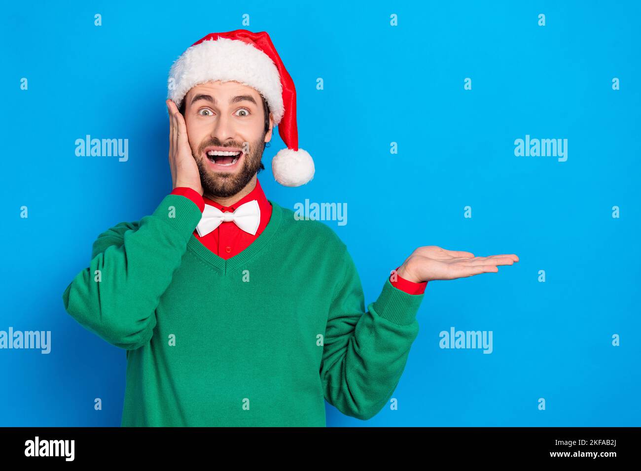 Portrait of impressed cheerful person arm touch cheek palm hold empty ...