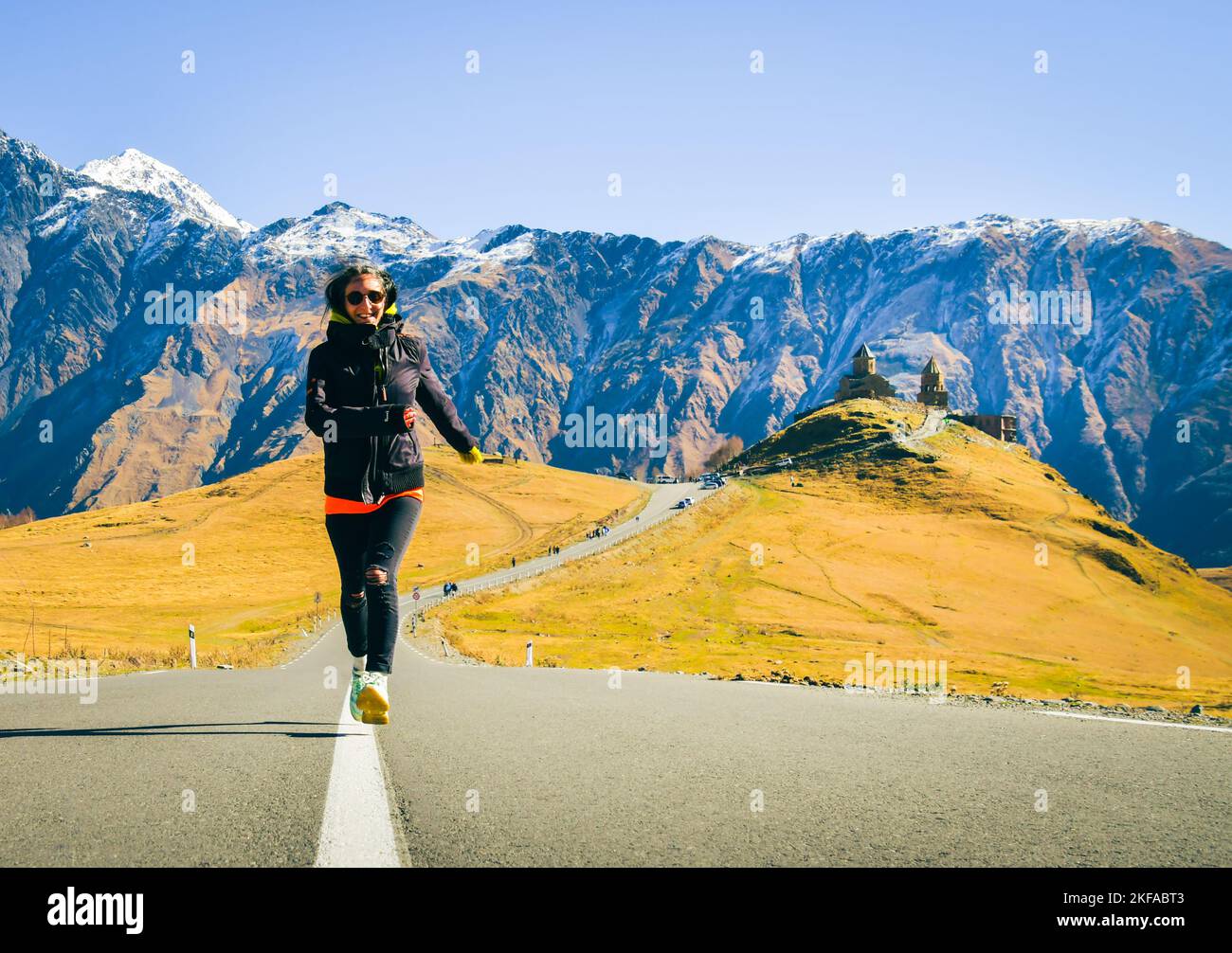 Tourist run by Gergeti trinity church in Georgia. Famous Gergeti ...