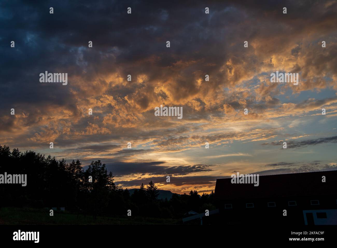 An amazing shot of a dramatic sunset over a field Stock Photo - Alamy