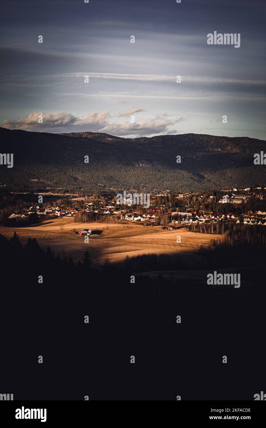 A forested green landscape and a small town seen from far away in ...