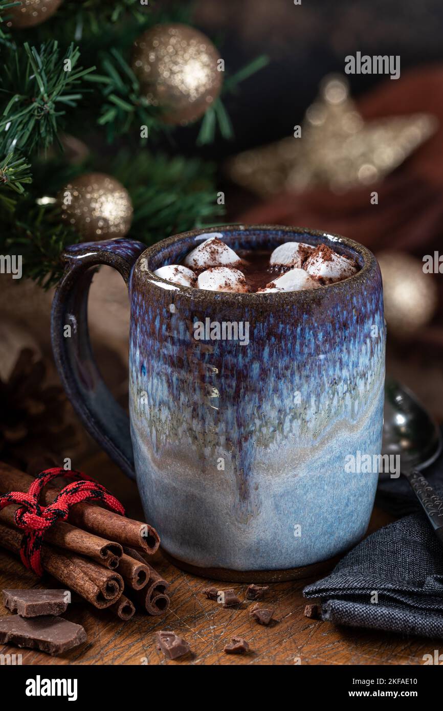 Mug of hot chocolate and marshmallows on a wooden table with Christmas ...