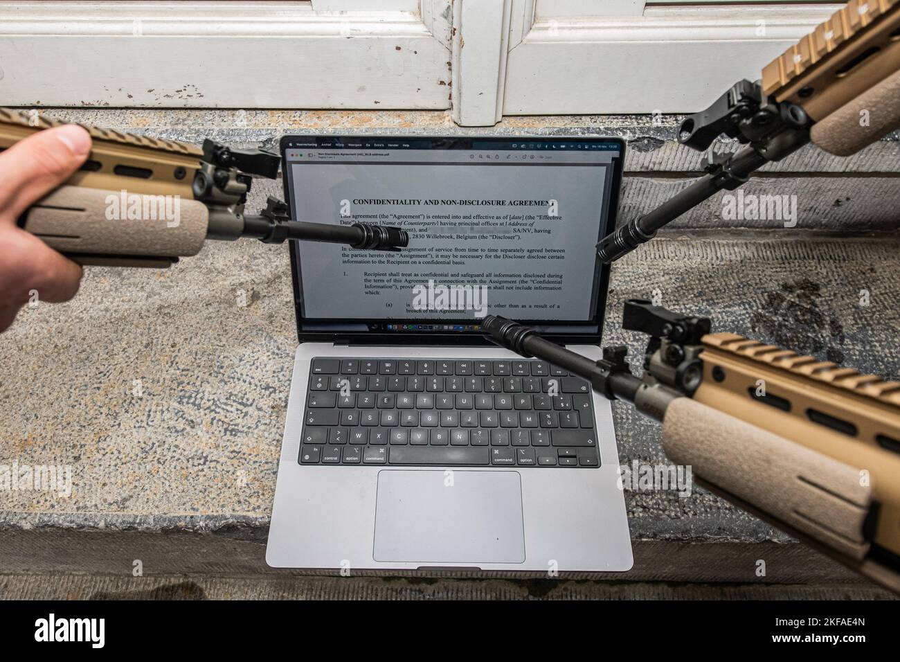 Military personel are seen pointing their rifles at a computer screen ...