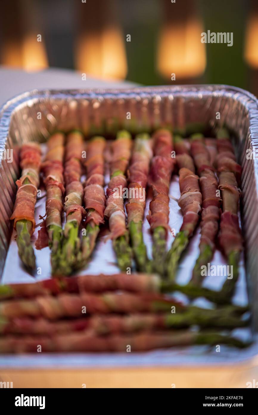 A vertical shot of Prosciutto-Wrapped Asparagus in a baking tray Stock ...