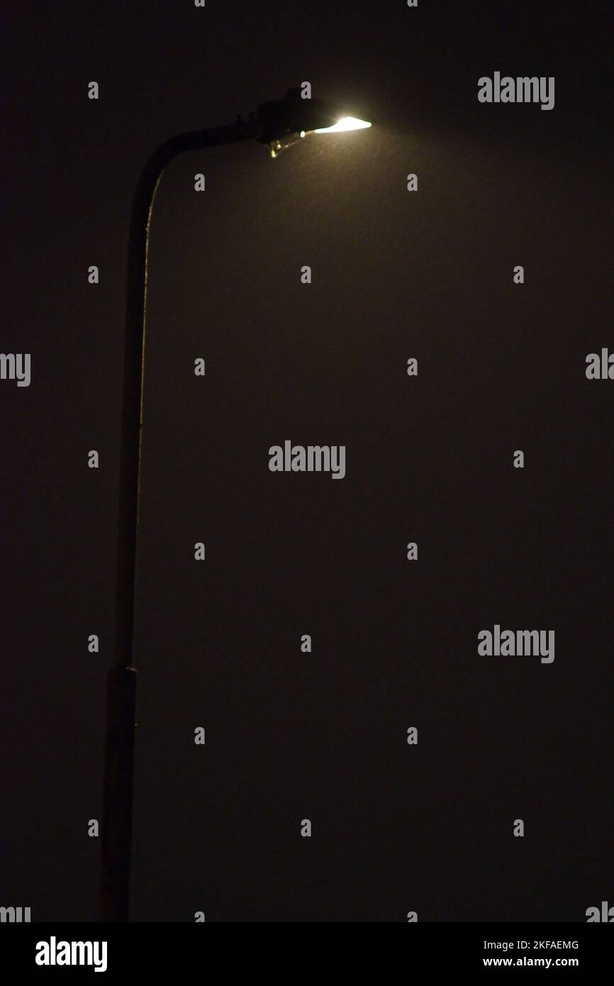 A street lighting pole isolated in the dark Stock Photo - Alamy