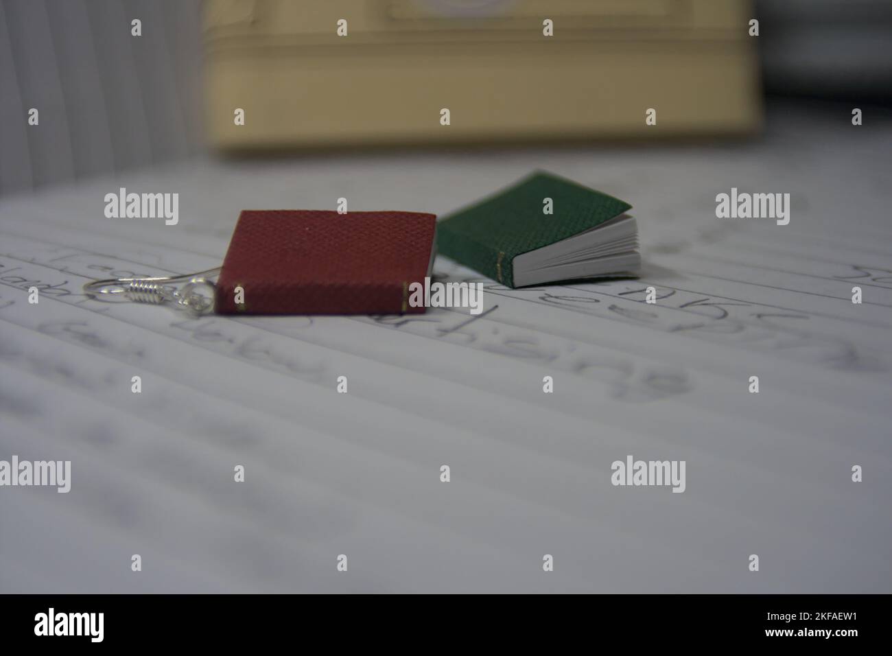 A closeup of red and green small book earrings on a paper Stock Photo ...