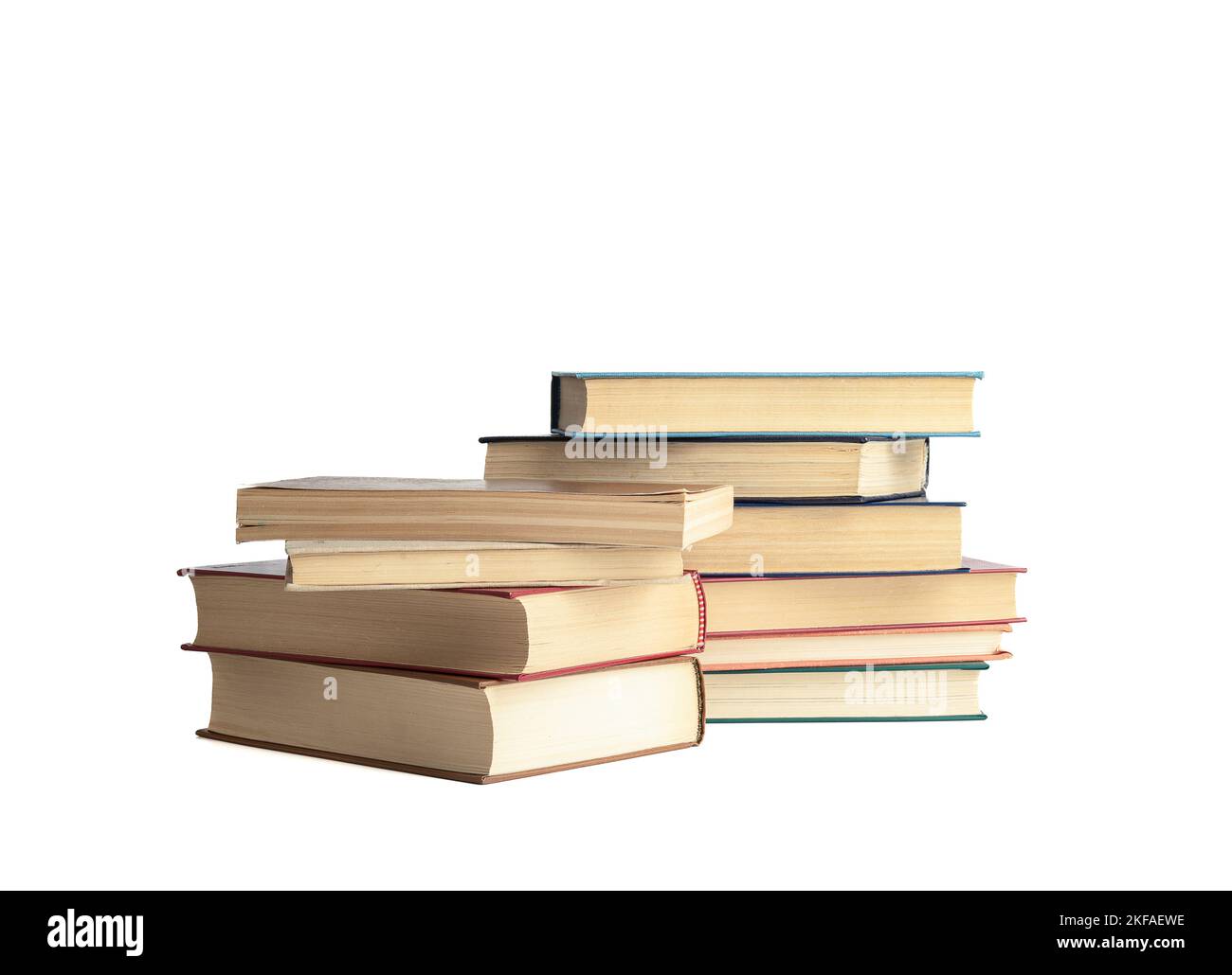 Stacks of books in hard and soft covers on a white background. Copy ...