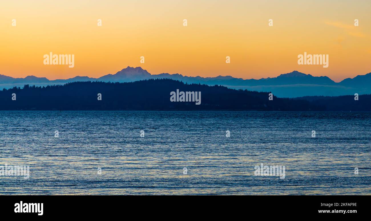 Sunset behind the Olumpic Mountains across the Puget Sound Stock Photo ...