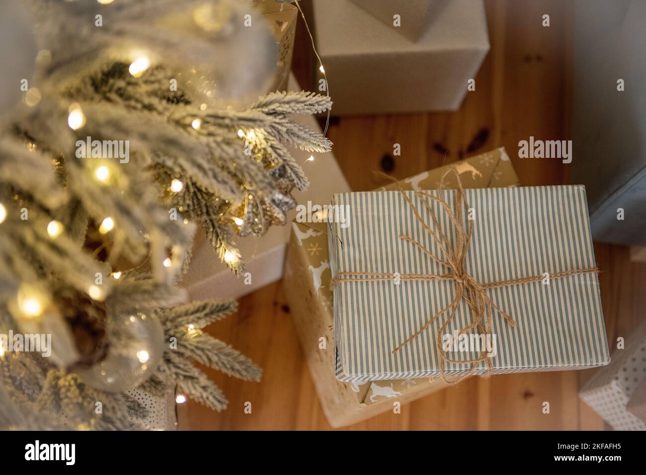 Wooden floor, laminate, boxes with gifts in white craft gold paper ...