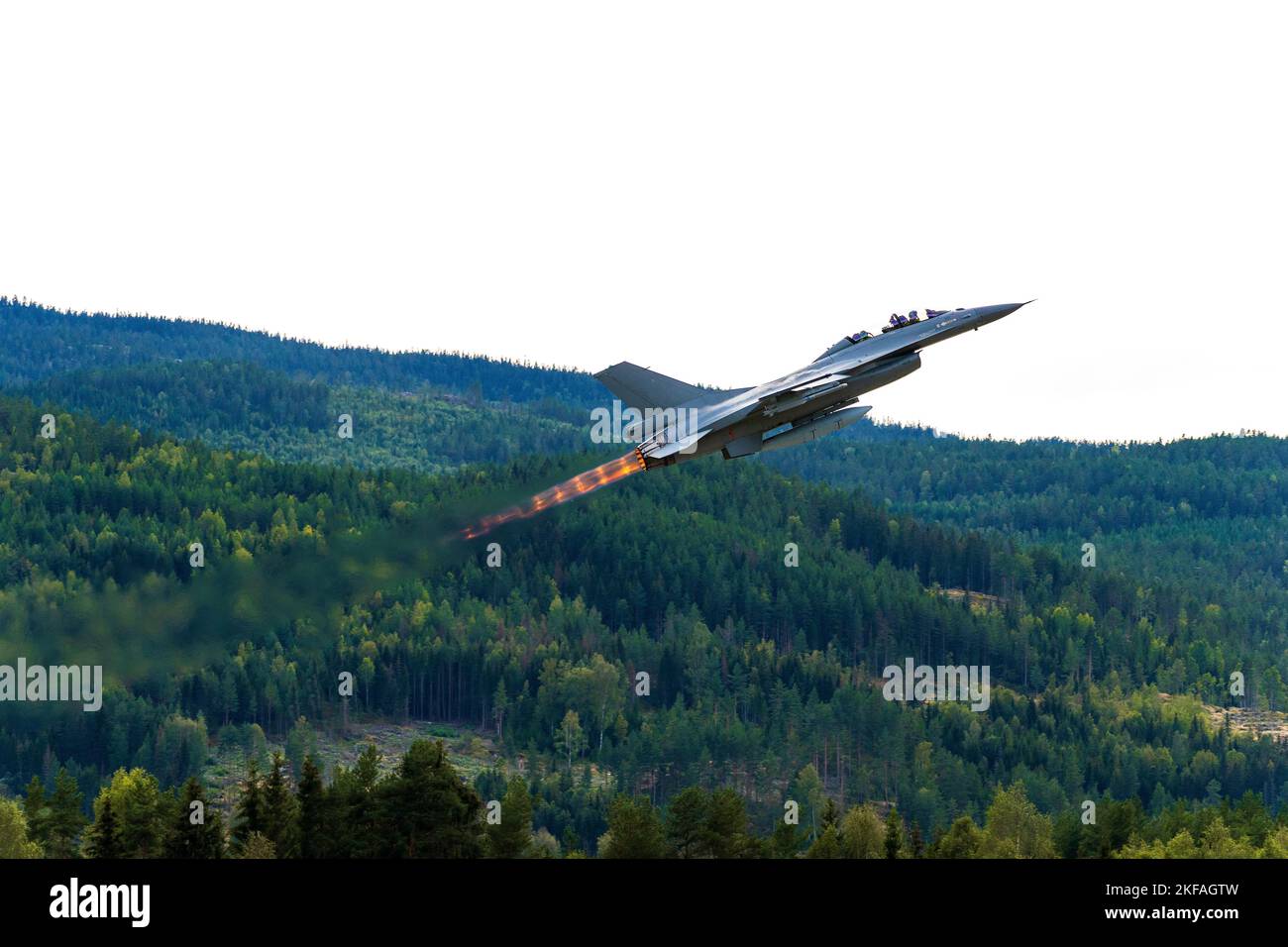 A low-angle shot of a fighter jet taking off with engine flames Stock ...