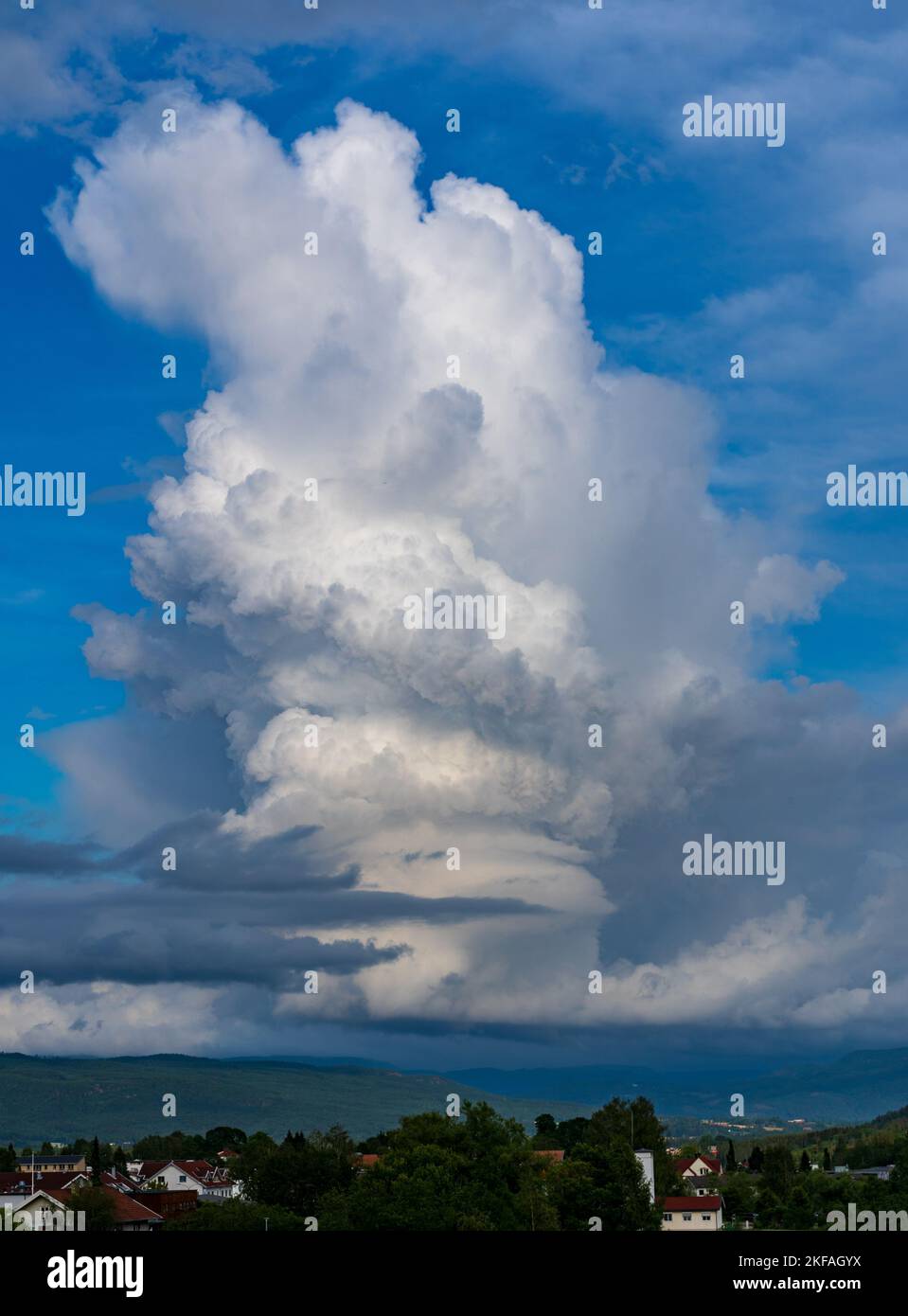 A vertical shot of white fluffy cloudscape in blue sky over the ...