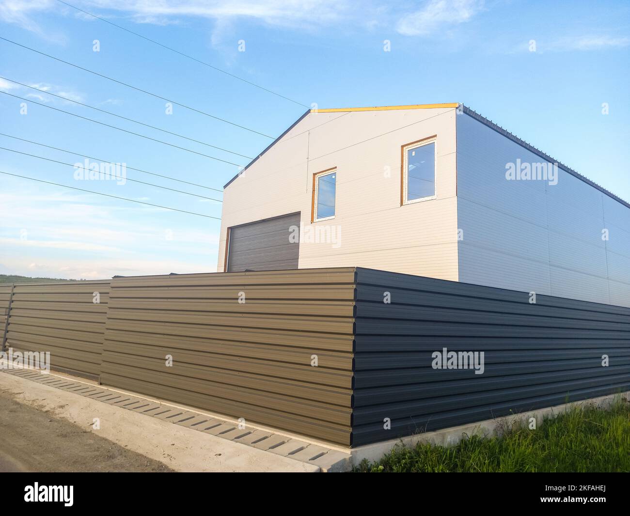 A side view of a fenced warehouse building used as a industrial ...