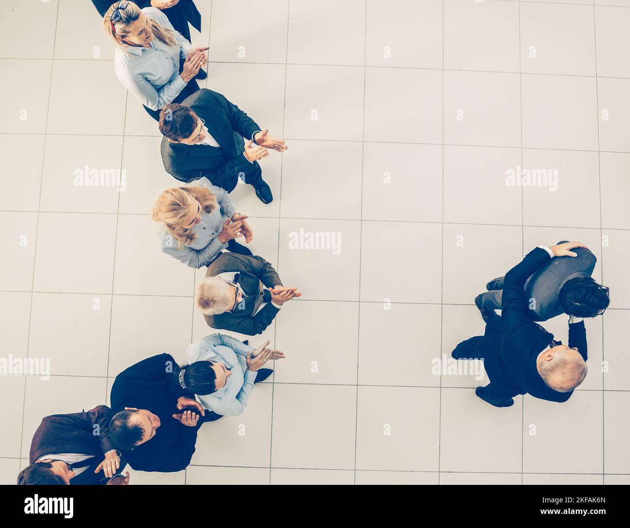 top view. business partners standing in front of a large group of ...