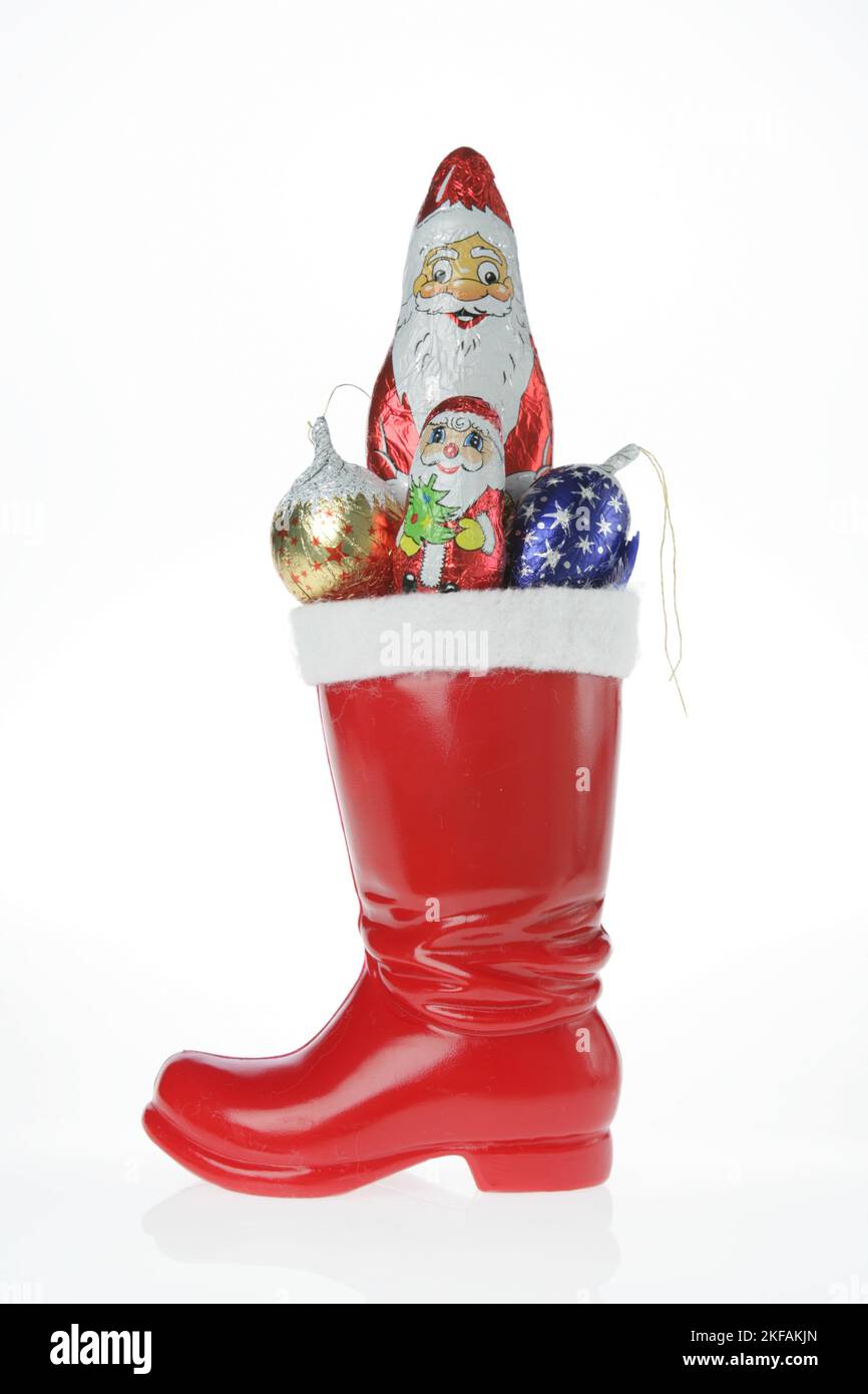 Santa Claus chocolate candy in a red Santa boot isolated on white ...