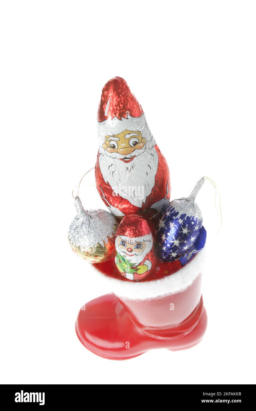 A Santa Claus chocolate candy in a red Santa boot isolated on white ...