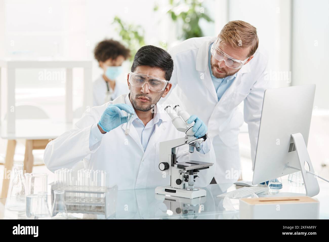 group of scientists is conducting research in a medical laboratory ...
