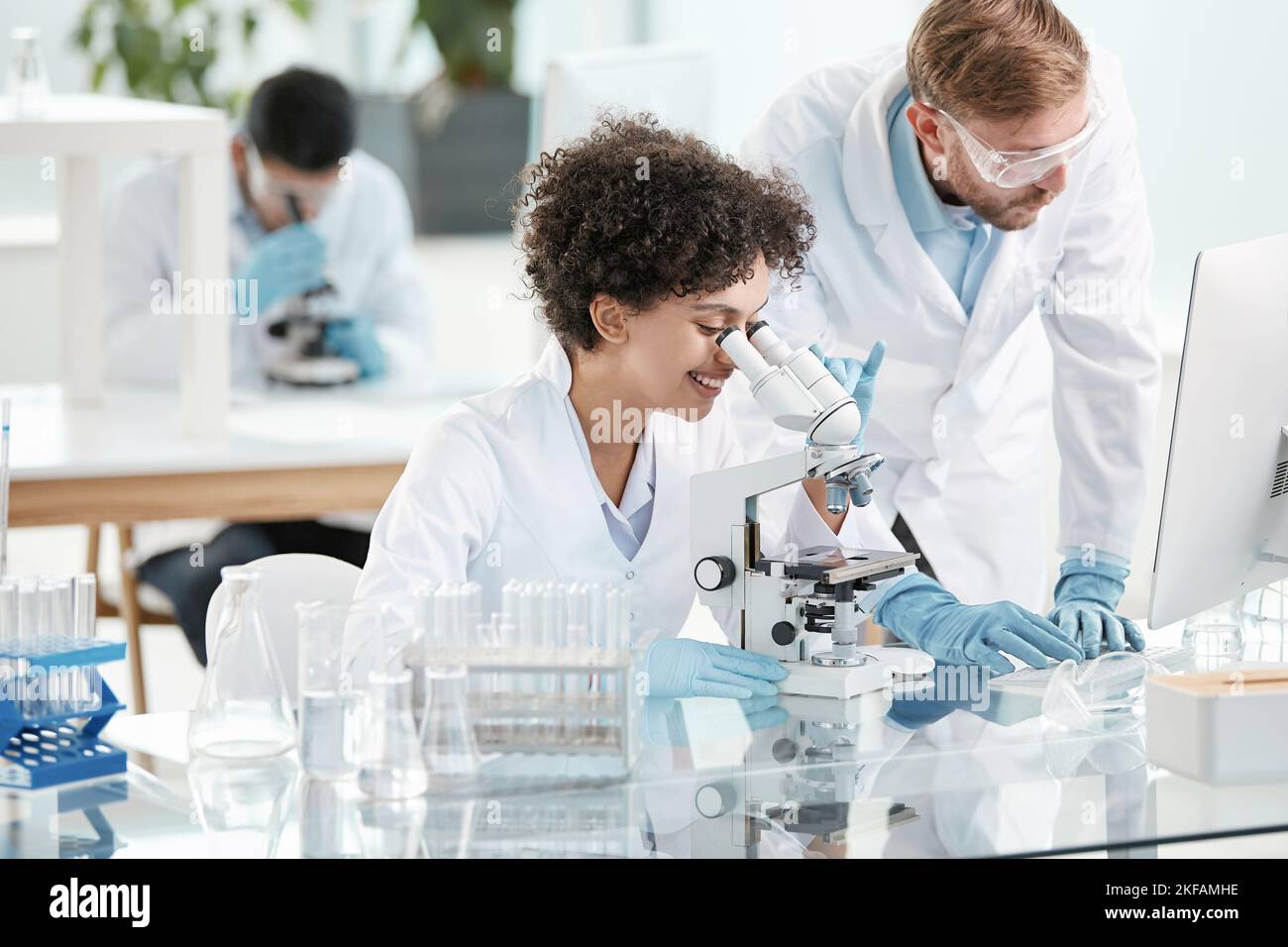 female scientist and her colleague are conducting research in the ...