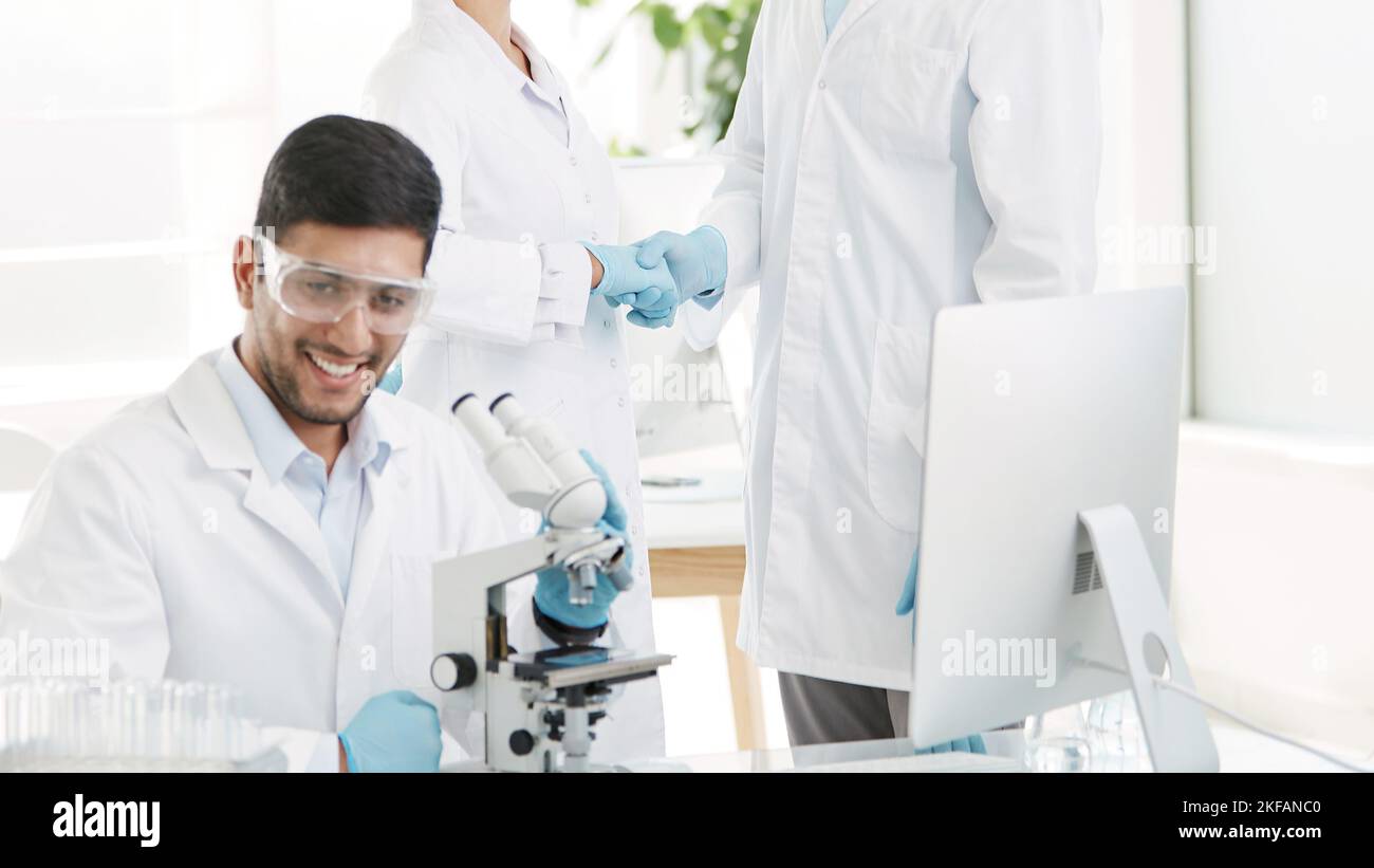 young scientists congratulating each other on their success Stock Photo ...