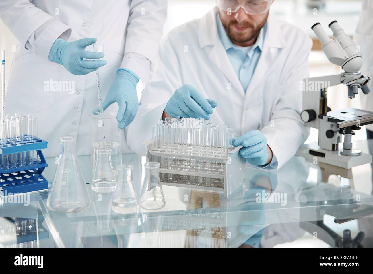 group of scientists testing liquid in laboratory tubes Stock Photo - Alamy