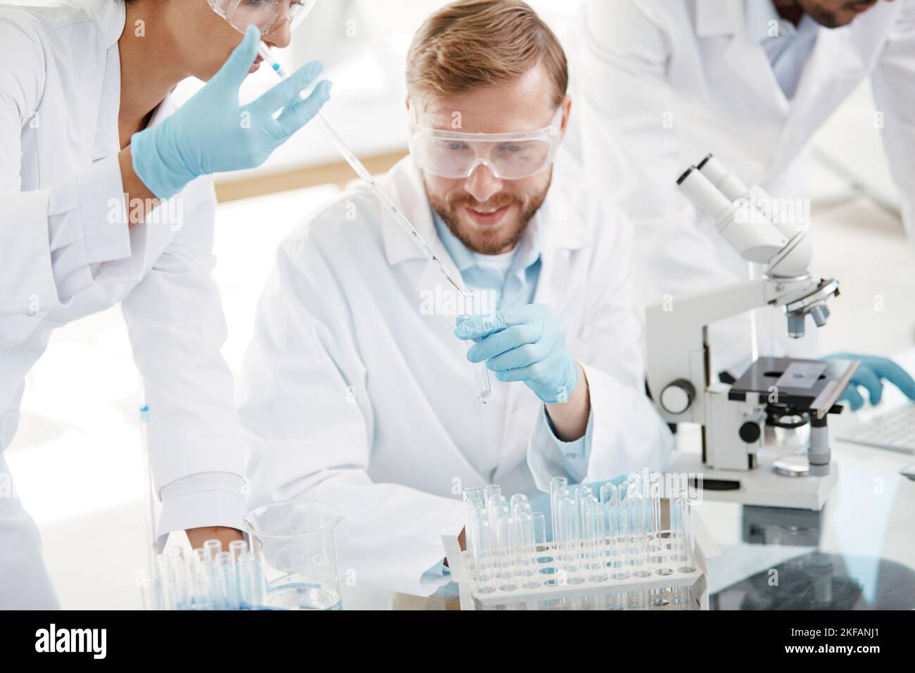 laboratory staff comparing liquid in laboratory tubes Stock Photo - Alamy
