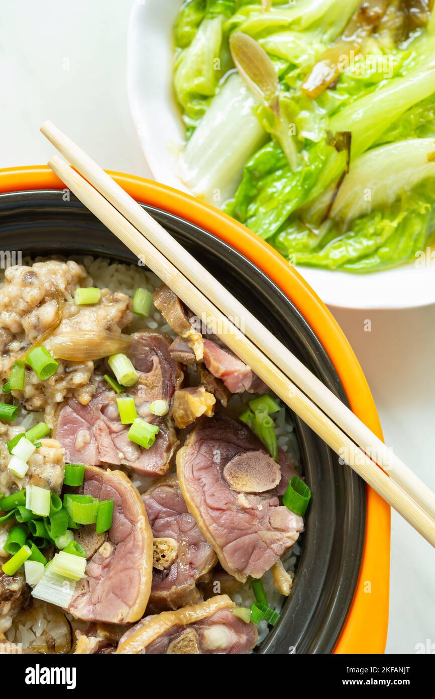 top view clay pot rice with pickled duck and chopped pork and vegetable ...