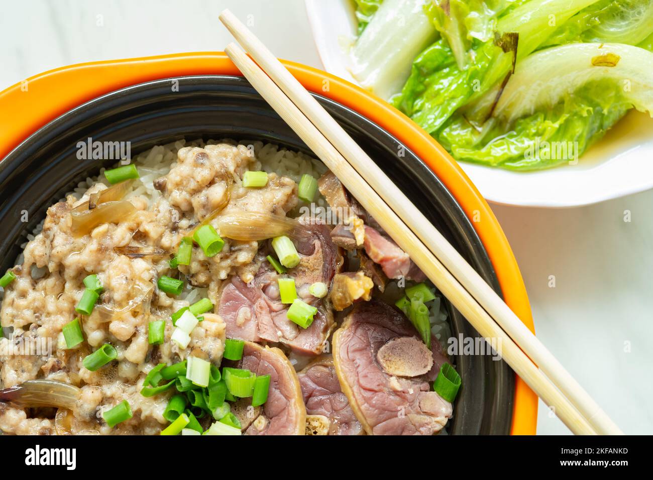 top view clay pot rice with pickled duck and chopped pork and vegetable ...