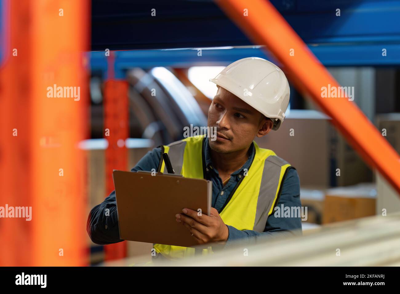 Working at warehouse. Male warehouse worker checking in storage ...