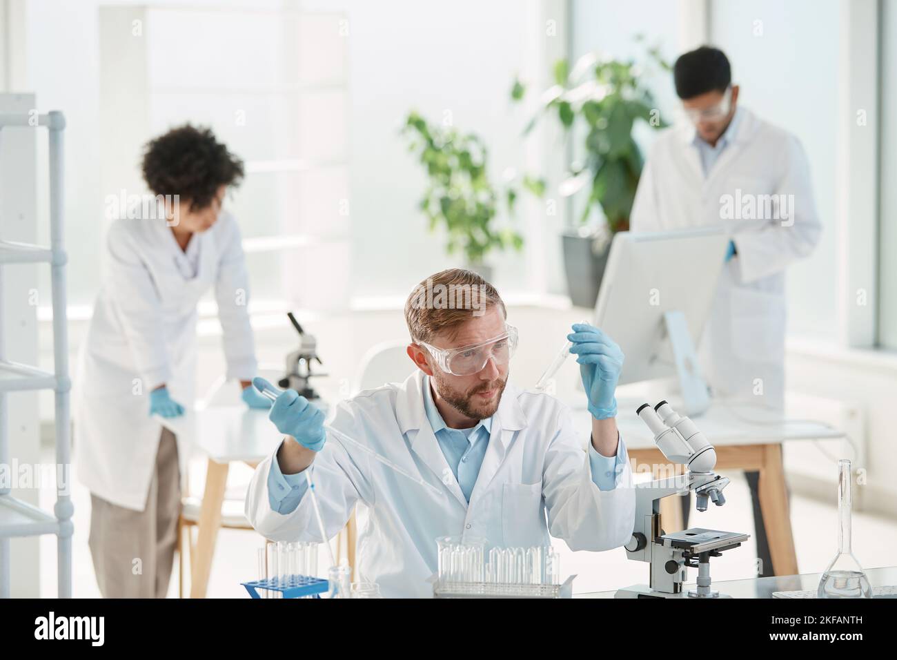 staff of the scientific medical laboratory congratulating each other on ...