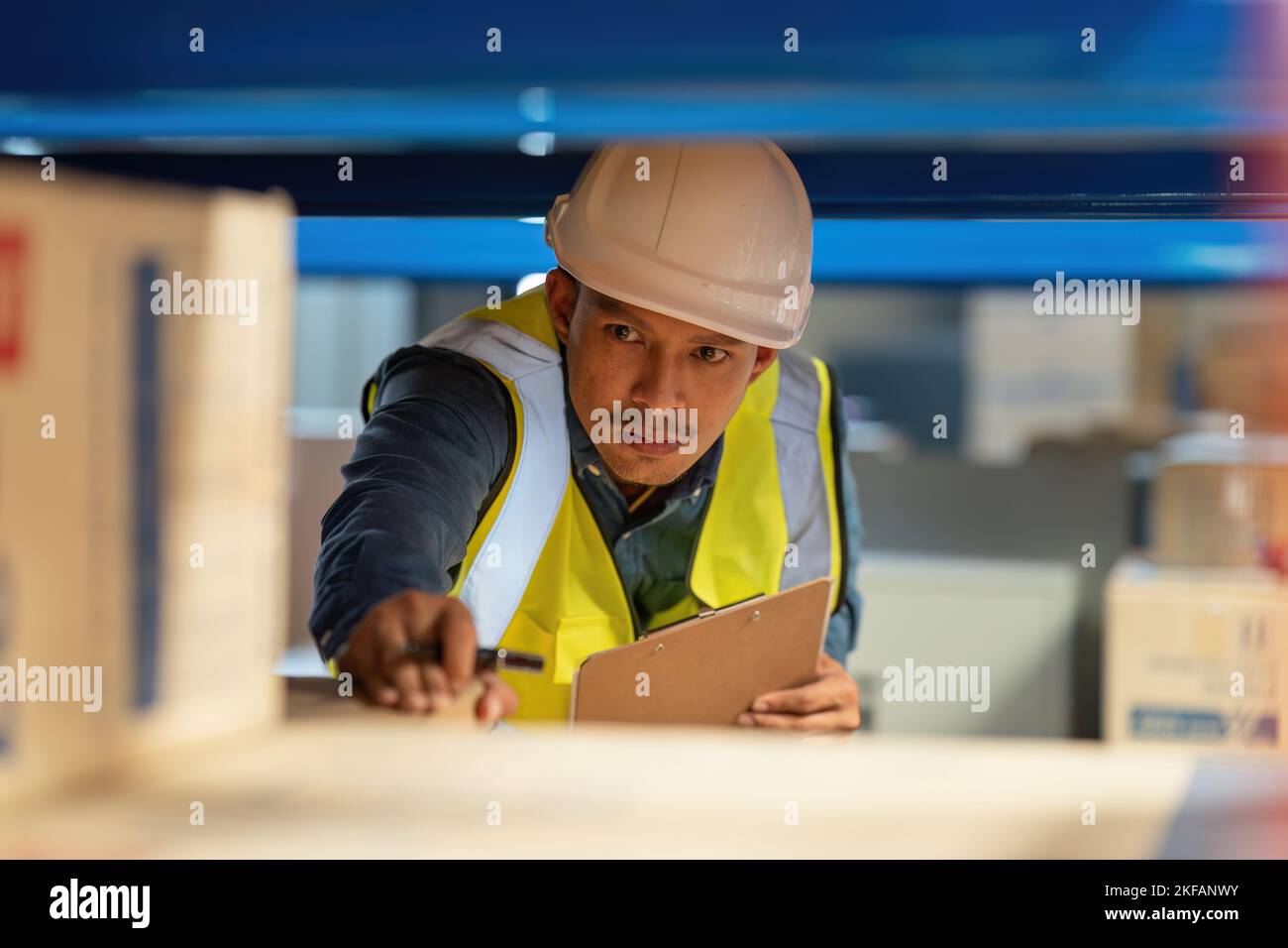 Working at warehouse. Male warehouse worker checking in storage ...