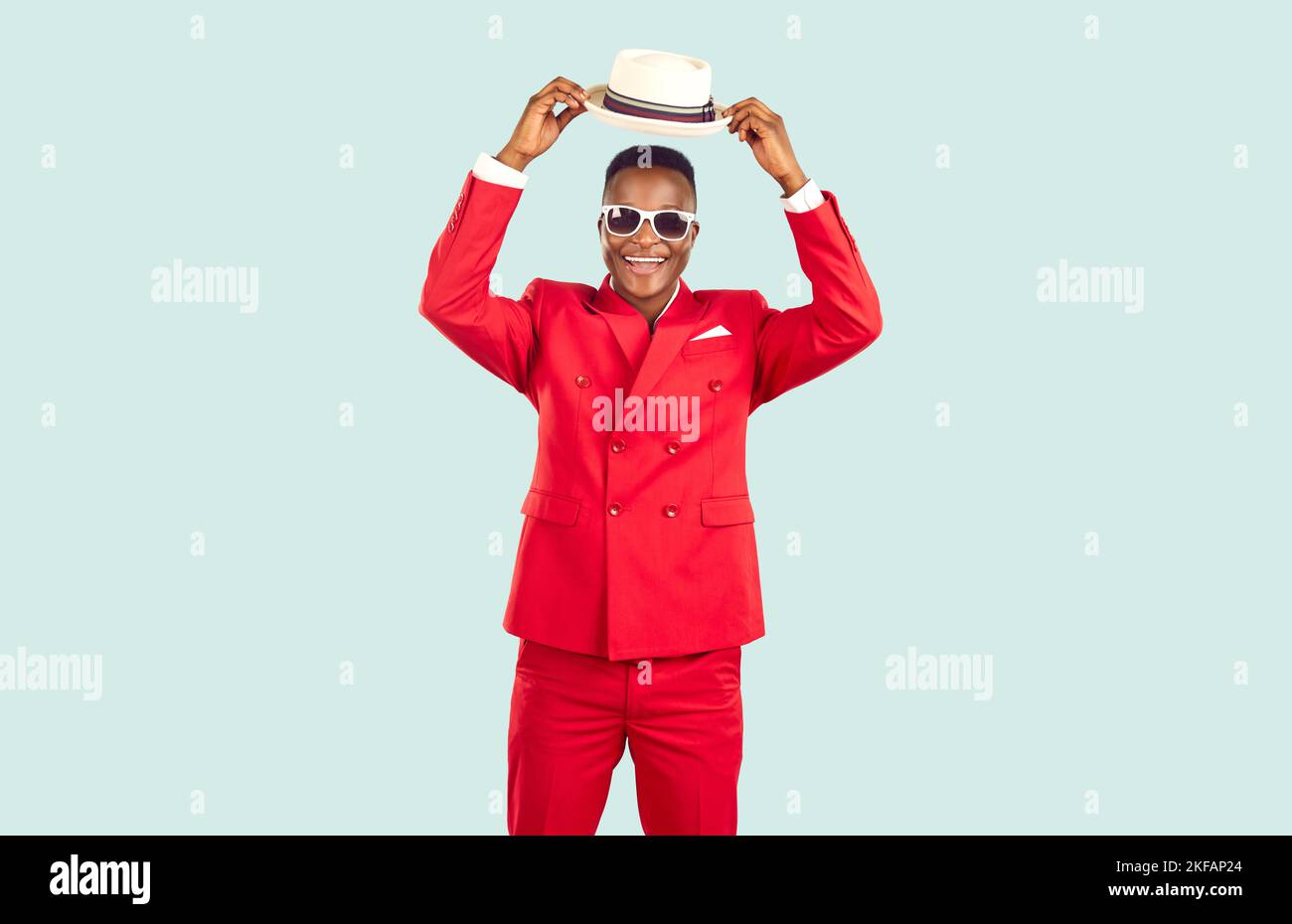 Happy African American man in trendy red suit and sunglasses smiles and ...