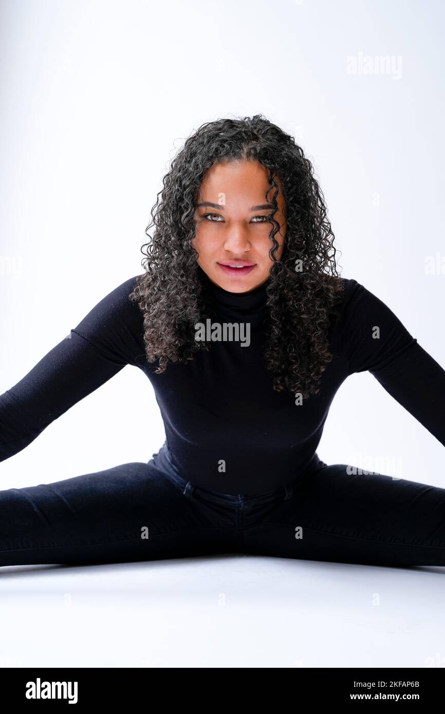 Young Multiracial Woman Doing the Splits on a White Background Looking ...
