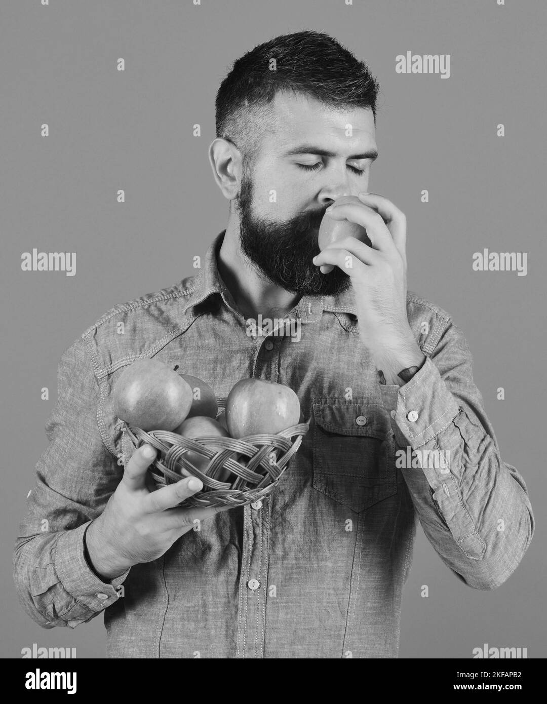 Farmer with dreamy face smells red apples Stock Photo - Alamy