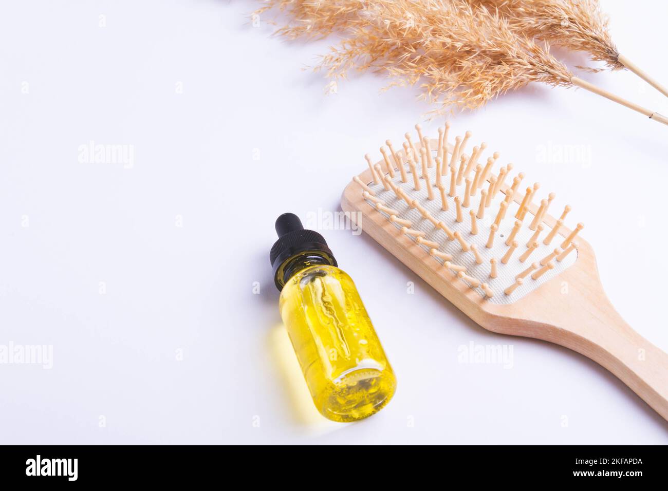 Oil for hair growth. Therapeutic oil to activate hair growth. Comb on ...