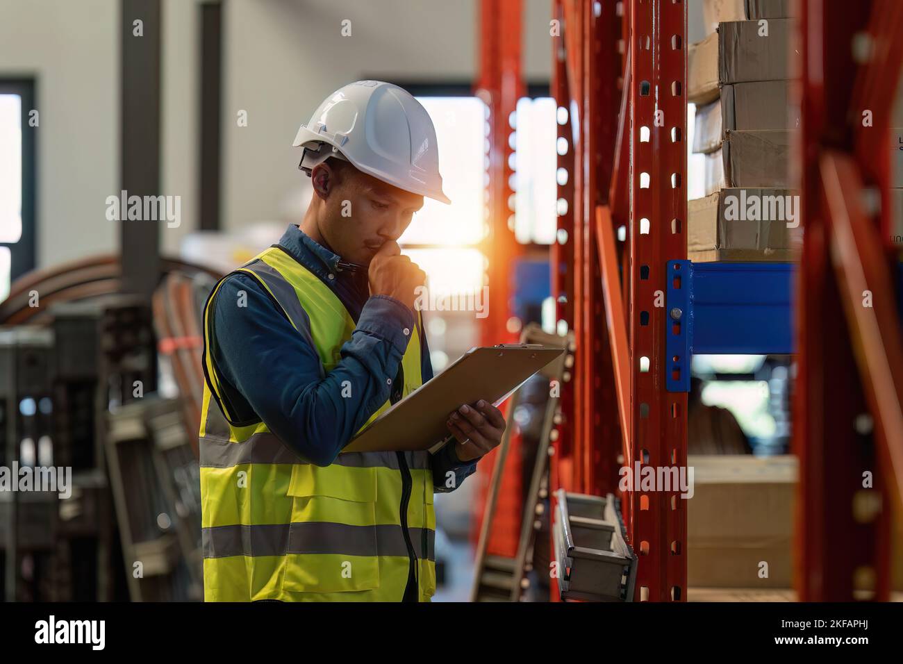 Working at warehouse. Male warehouse worker checking in storage ...