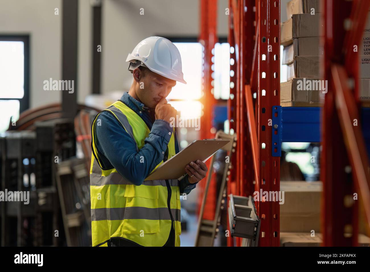 Working at warehouse. Male warehouse worker checking in storage ...