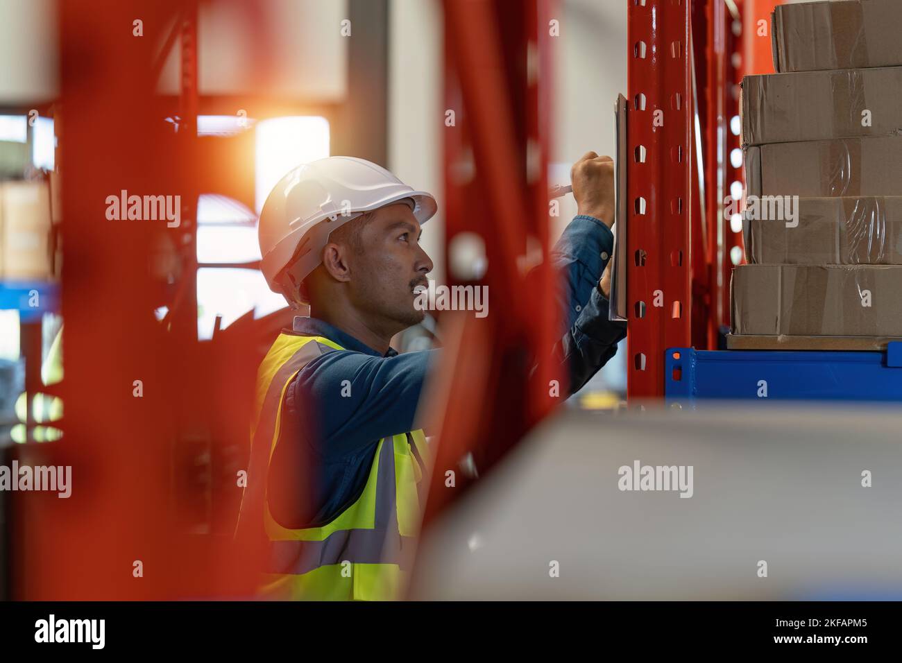 Working at warehouse. Male warehouse worker checking in storage ...