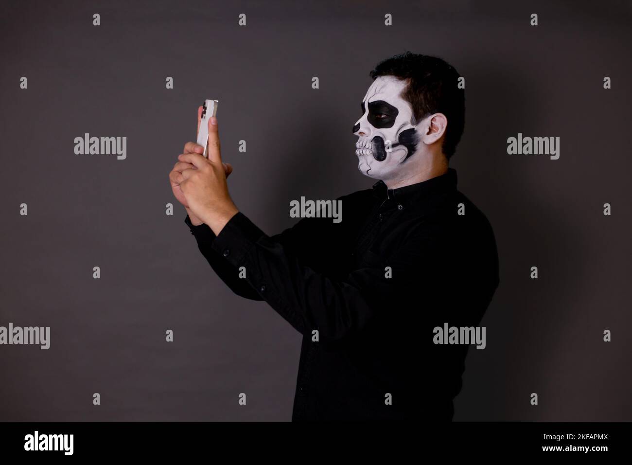 man in catrin or skull makeup for day of the dead as mexican tradition ...
