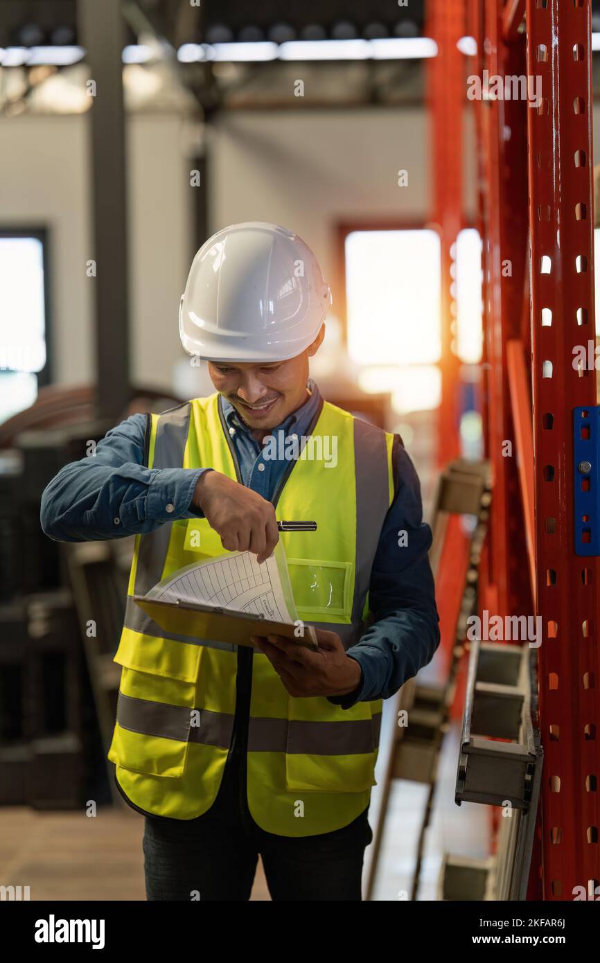Working at warehouse. Male warehouse worker checking in storage ...
