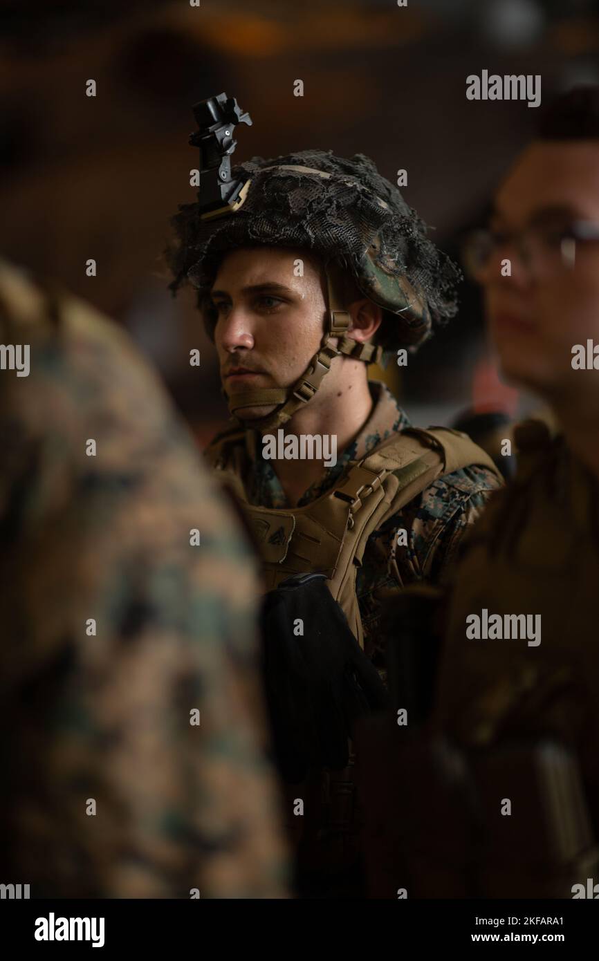 U.S. Marines with 3d Marine Division, wait to weigh in with their gear ...