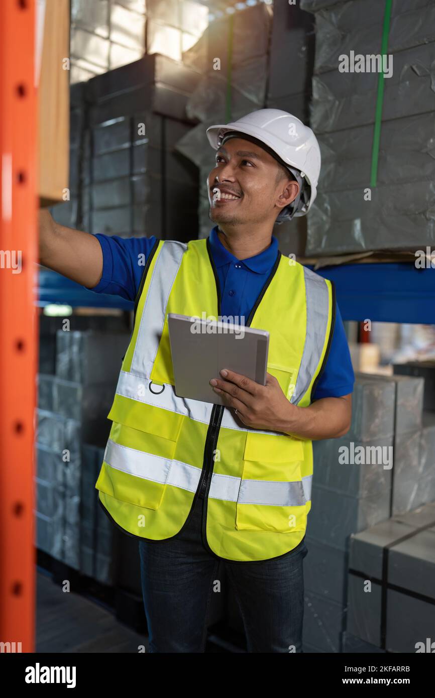 Working at warehouse. Male warehouse worker checking in storage ...