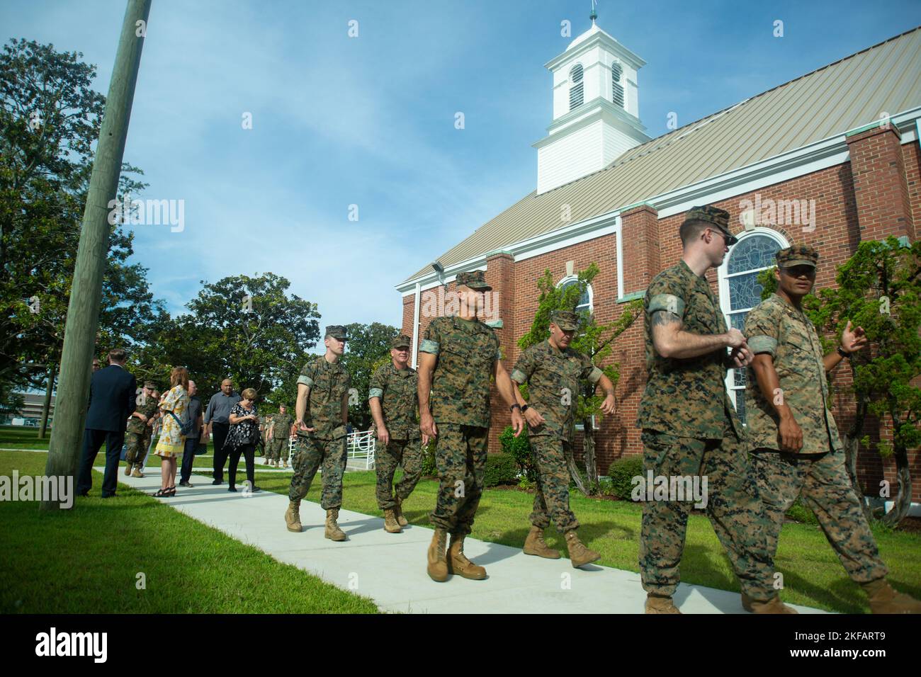 Service members and families walk inside the protestant chapel after ...