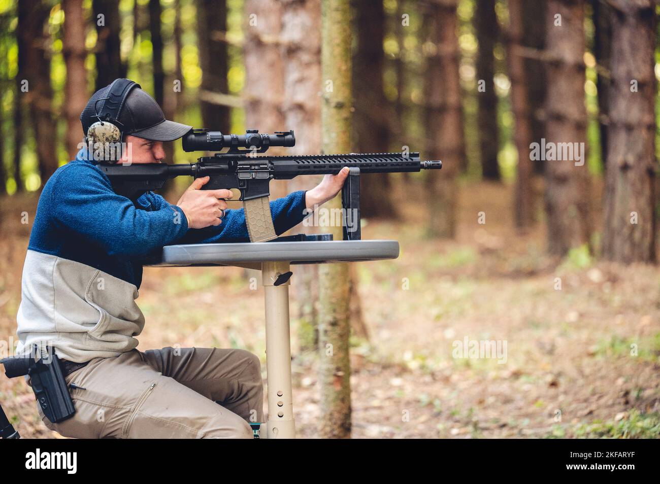A man shooting gun at an outdoor shooting range Stock Photo - Alamy
