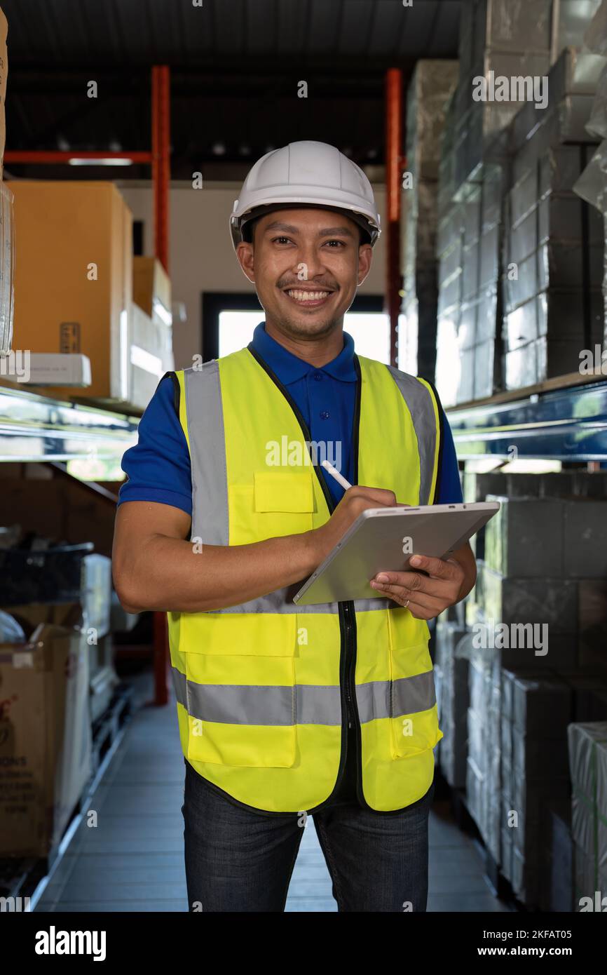 Working at warehouse. Male warehouse worker checking in storage ...