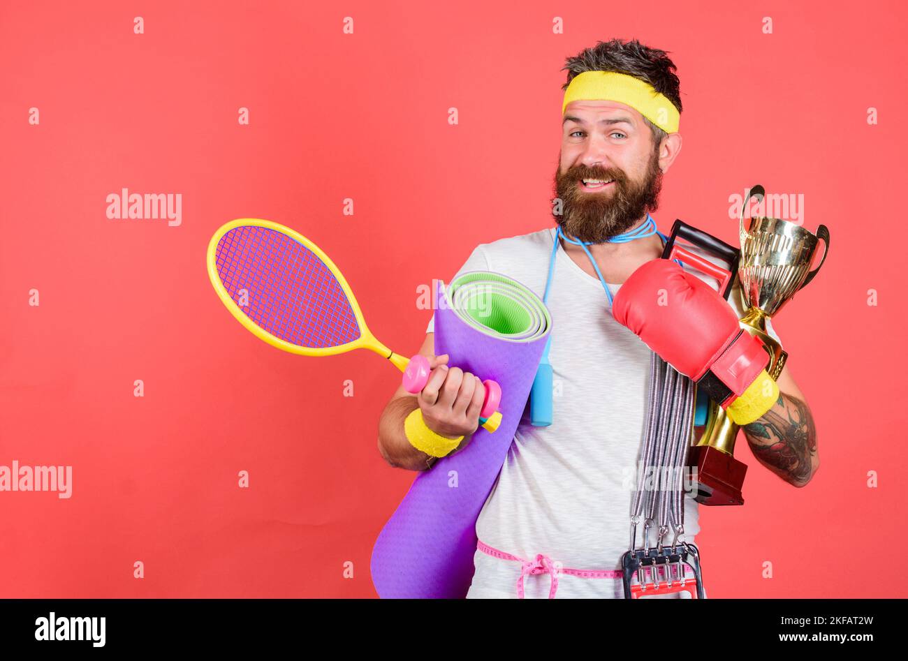 Man bearded athlete hold sport equipment jump rope fitness mat boxing ...