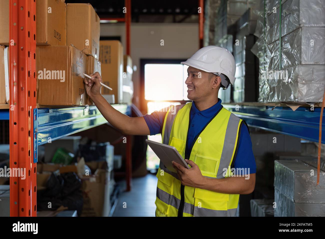 Working at warehouse. Male warehouse worker checking in storage ...
