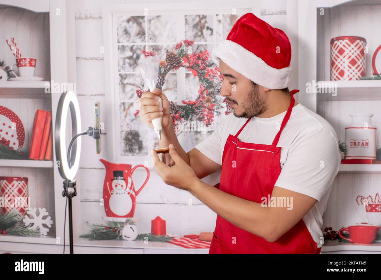 caucasian cheerful man making and decorating christmas cookies to ...