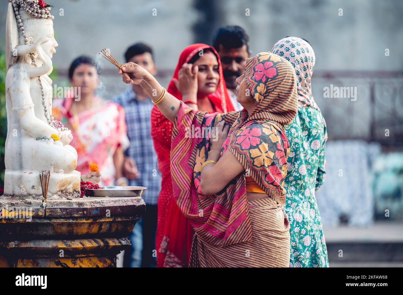 A group of women praying to idols and guards at the Narasimha Hindu ...
