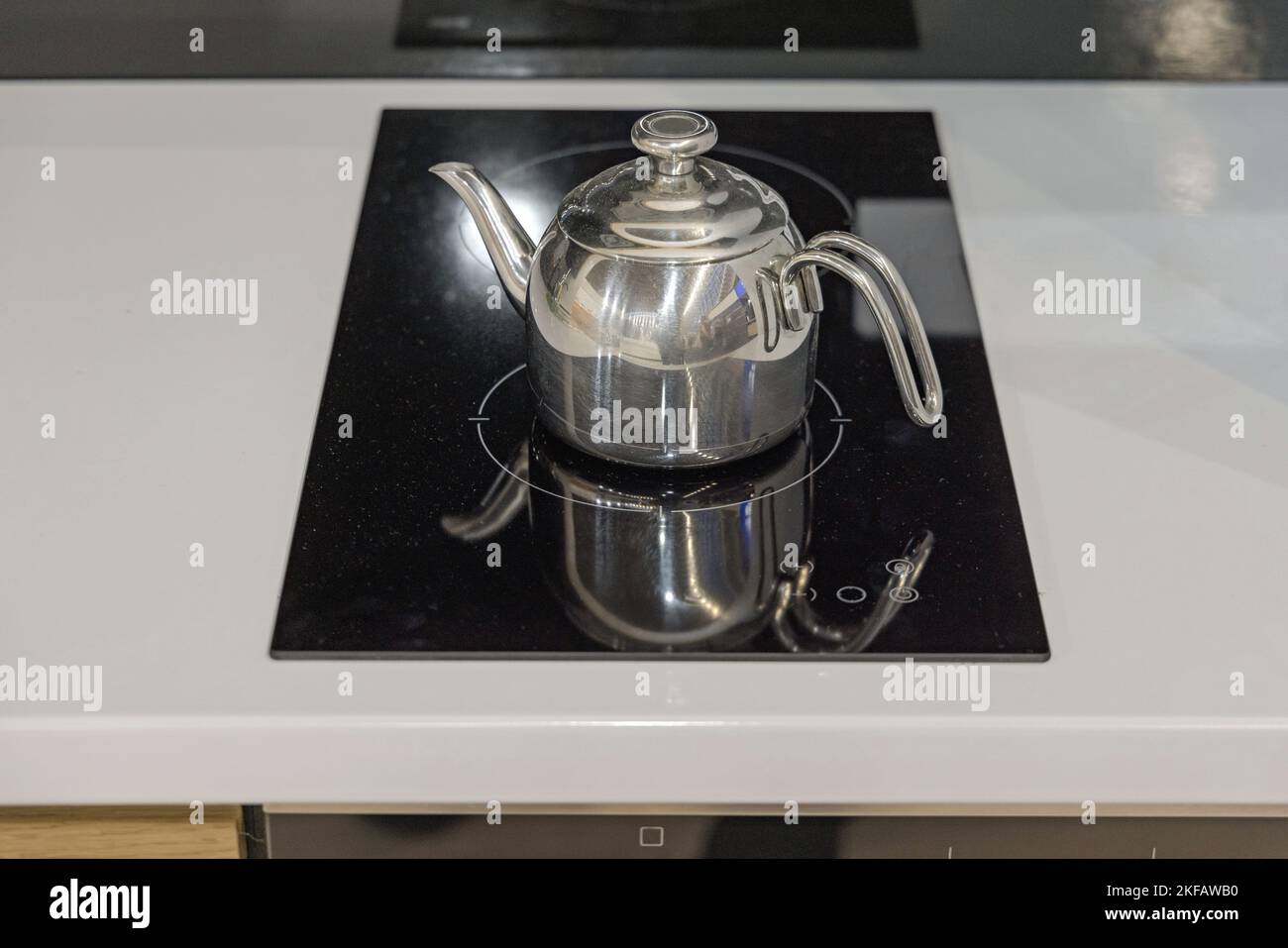 Stainless Steel Tea Kettle at Induction Cooktop in Modern Kitchen Stock ...