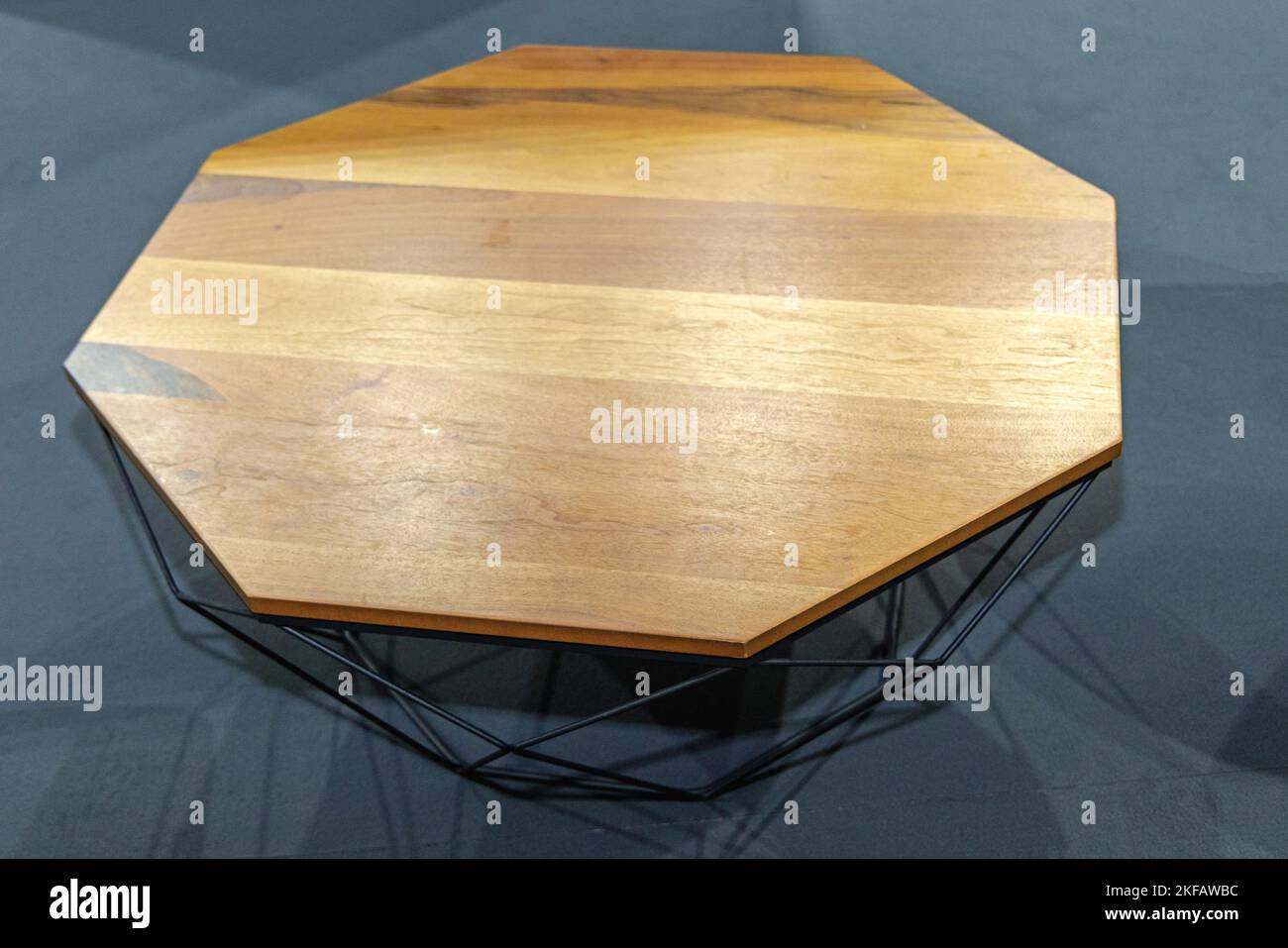 Modern Octagonal Shape Wooden Coffee Table at Dark Floor Stock Photo - Alamy